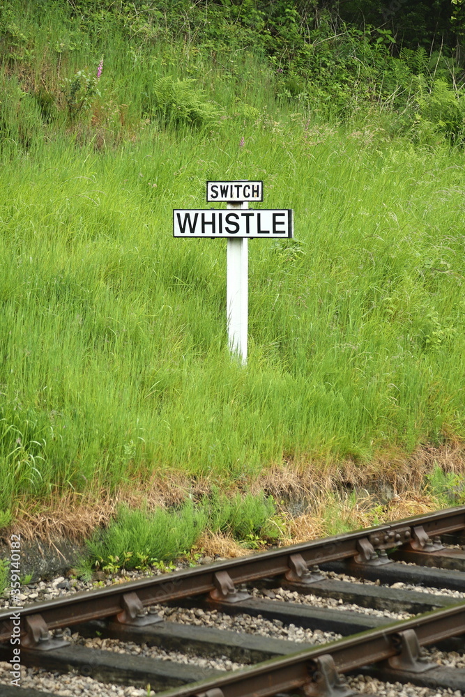 Whistle Railway Sign. The view across railway track towards a sign ...