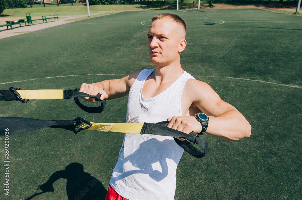 Athlete guy does pectoral muscle wiring, trains in summer city, holds ...