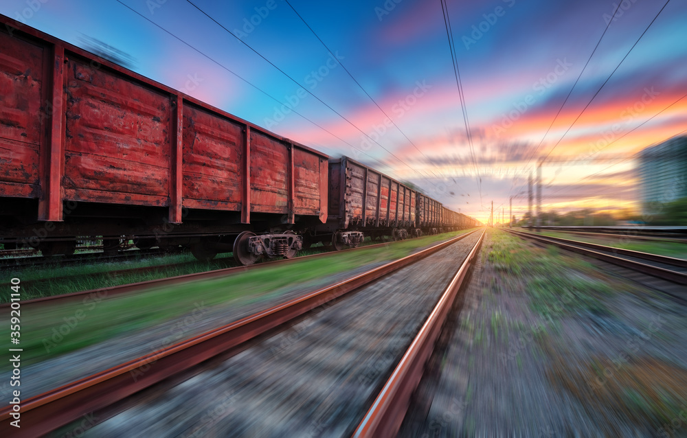 Moving freight train at sunset. Railroad and beautiful sky with clouds ...