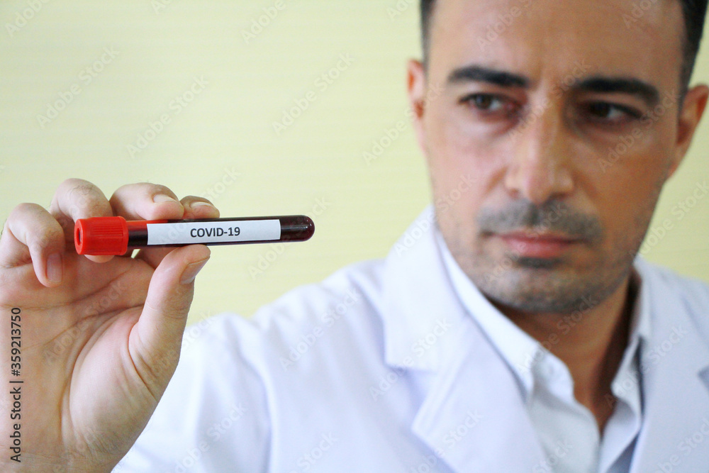 Caucasian Scientific experimenter hand holding Blood test of people ...