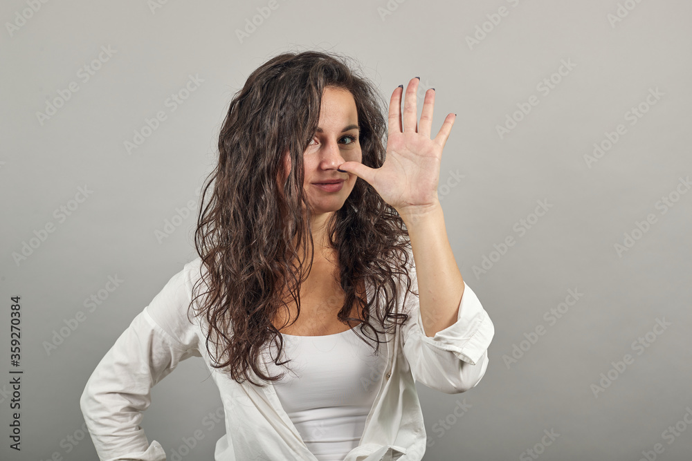 Pulling face, holding thumb to nose, teasing is putting fingers to head ...