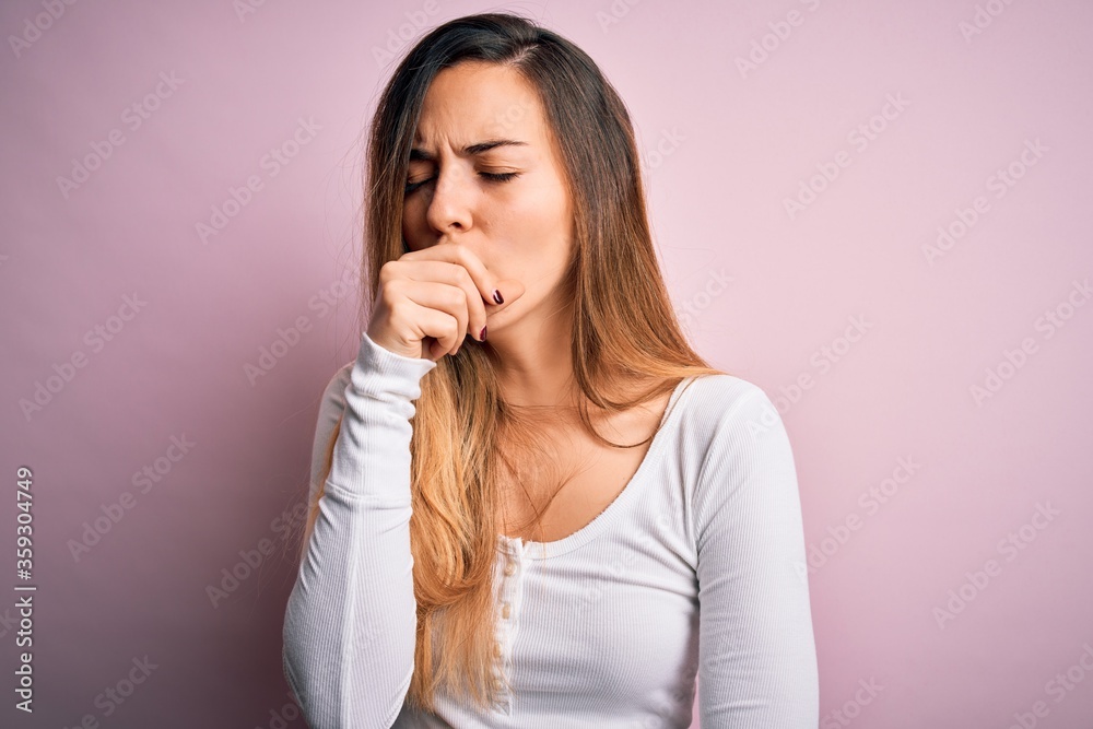 Young beautiful blonde woman with blue eyes wearing white t-shirt over ...