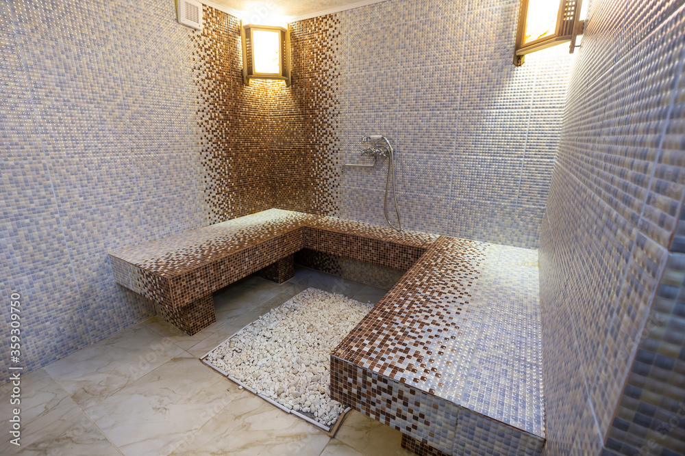 Hamam, traditional turkish sauna. Classic hammam interior design. Mosaic walls and benches ...