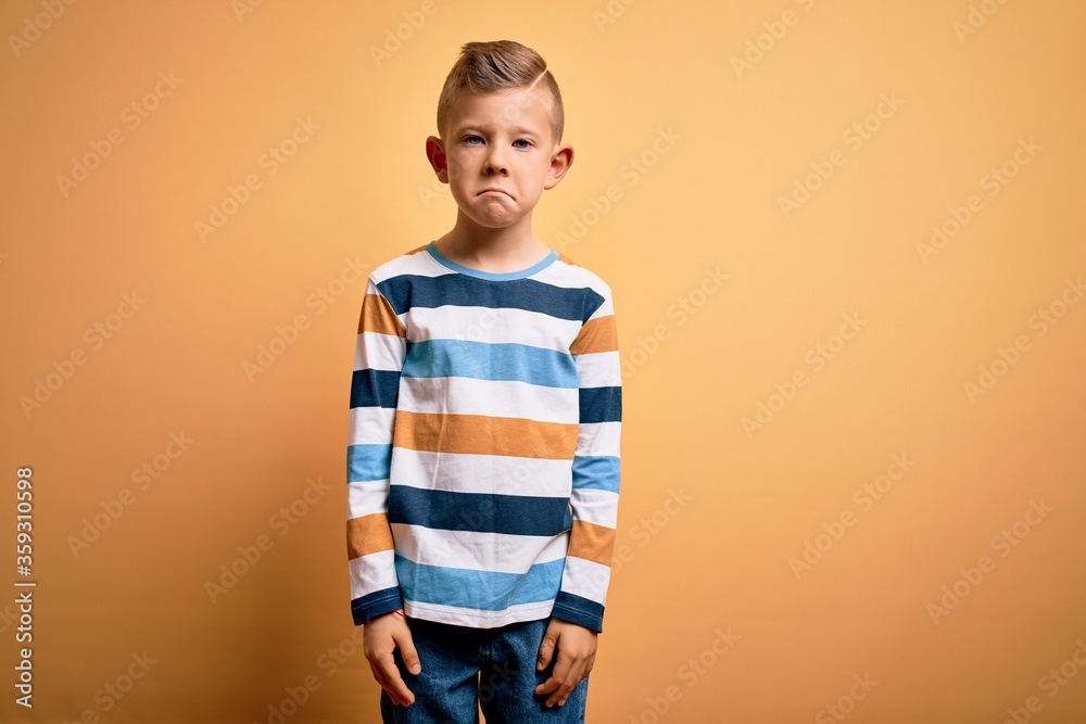 Young little caucasian kid with blue eyes wearing colorful striped ...