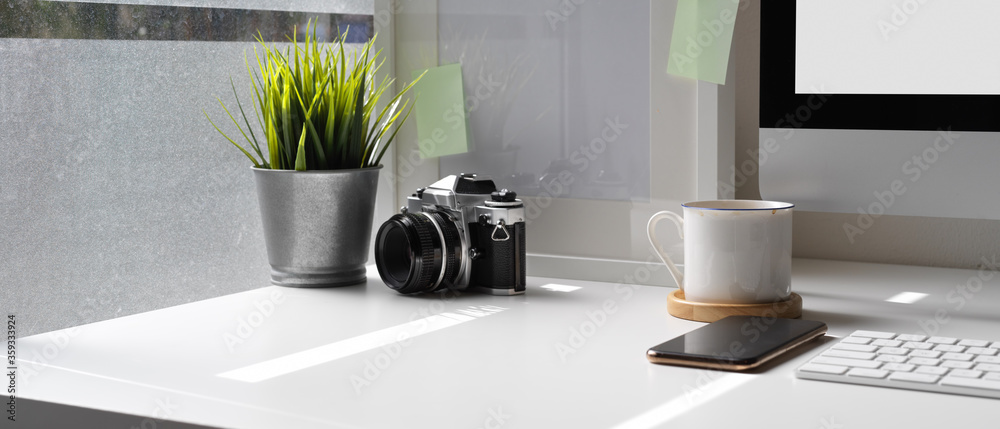 Modern office desk with computer device, smartphone, camera, supplies ...