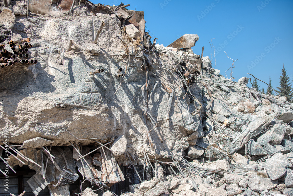 Fragments of the destroyed building. Fragments of concrete walls and ...