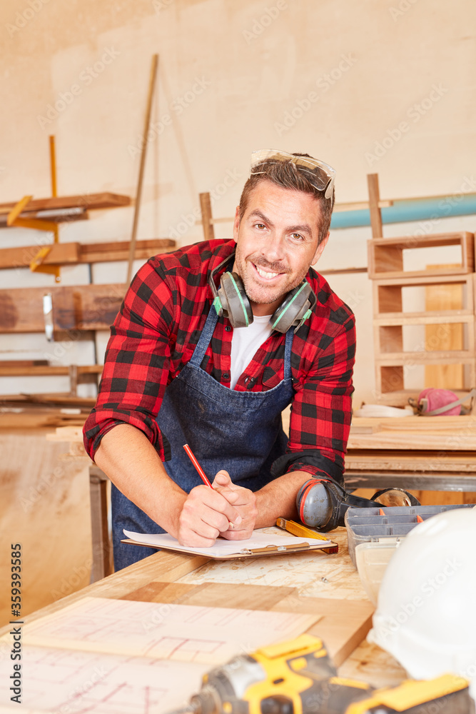Young man as a craftsman with checklist Stock Photo | Adobe Stock