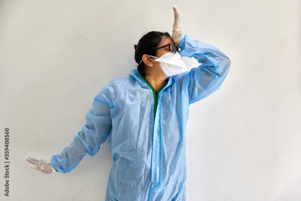 Lady medical professional wearing a blue hazmat suit(PPE), white N95 ...