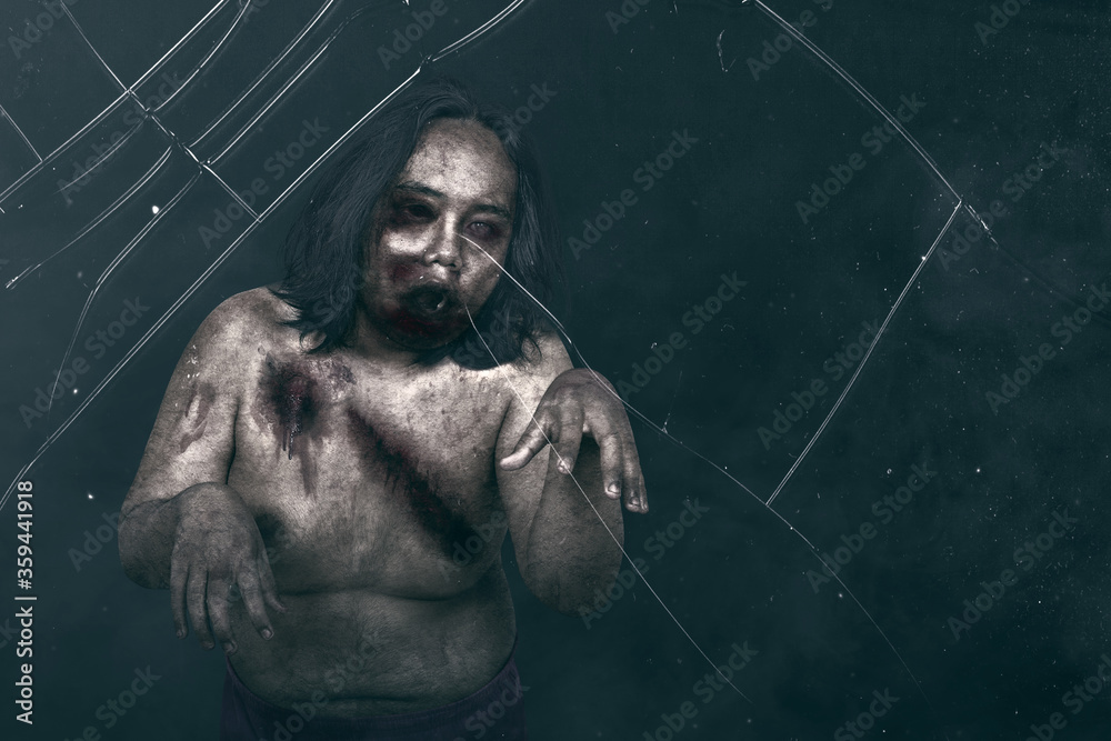 Scary zombie with blood and wound on his body standing Stock Photo ...