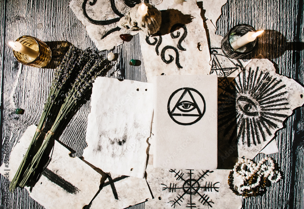White magic book laying on the table with old manuscripts with occult ...