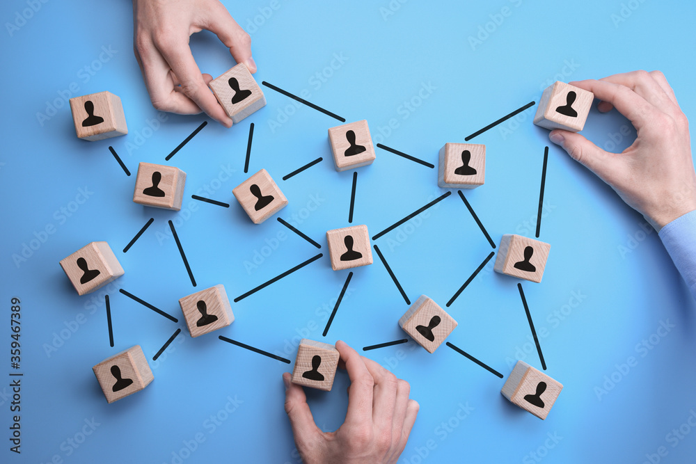 Network Community - man hands put the wooden bricks with person icon on ...