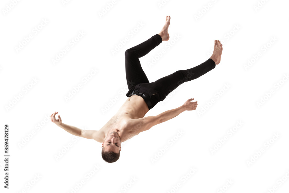 Foto de Mid-air beauty cought in moment. Full length shot of young man ...