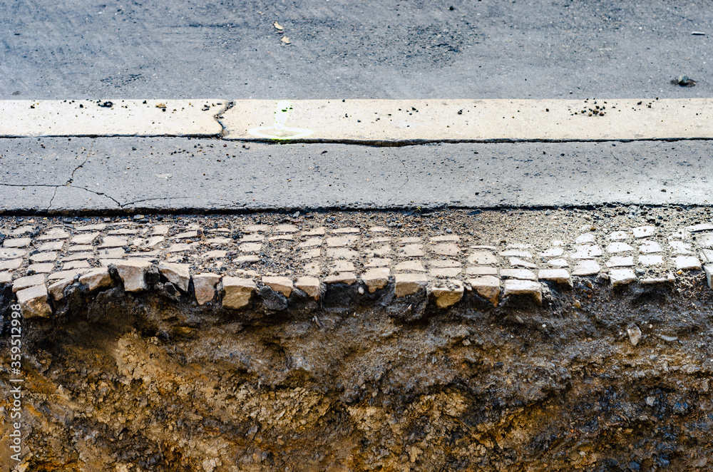 Sidewalk under reconstruction - a layer of old classical stone pavement ...