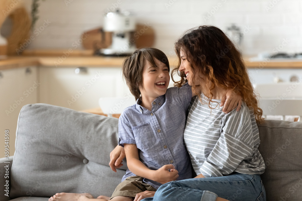 Smiling mother and little son hugging looking at each other. Loving mum ...