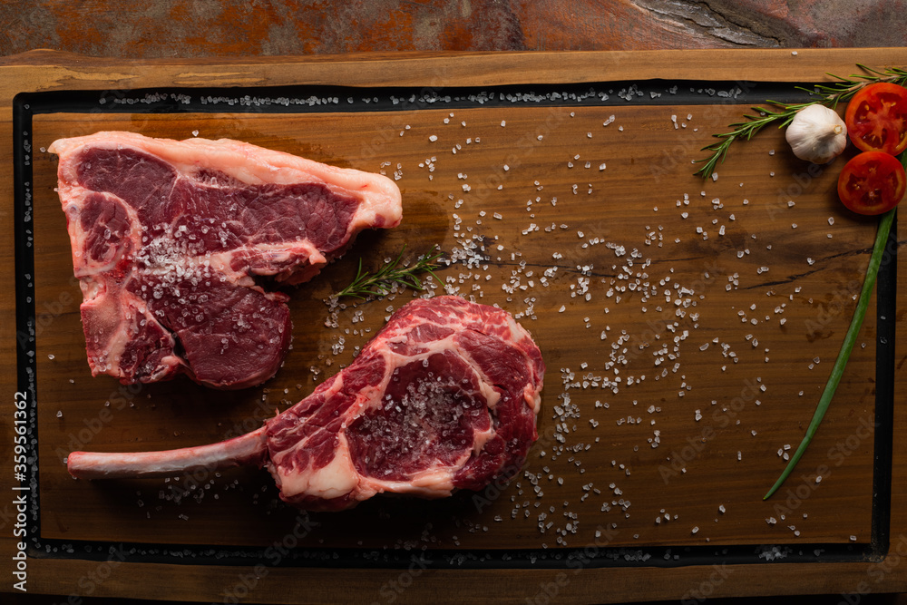 Top view raw tomahawk and Tibone with bone beef steak with ingredients ...
