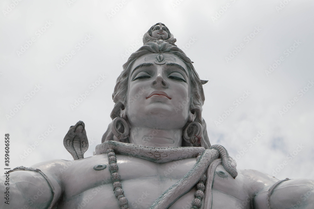 RISHIKESH, INDIA , Statue of Shiva, Hindu idol near Ganges River water ...