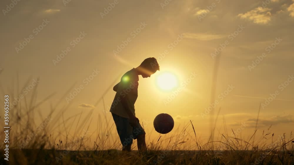 The path to the dream. The silhouette of a child chasing a ball with ...