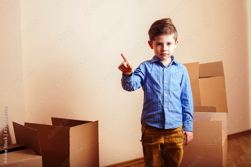 little cute boy in empty room, move to new house. home alone among ...