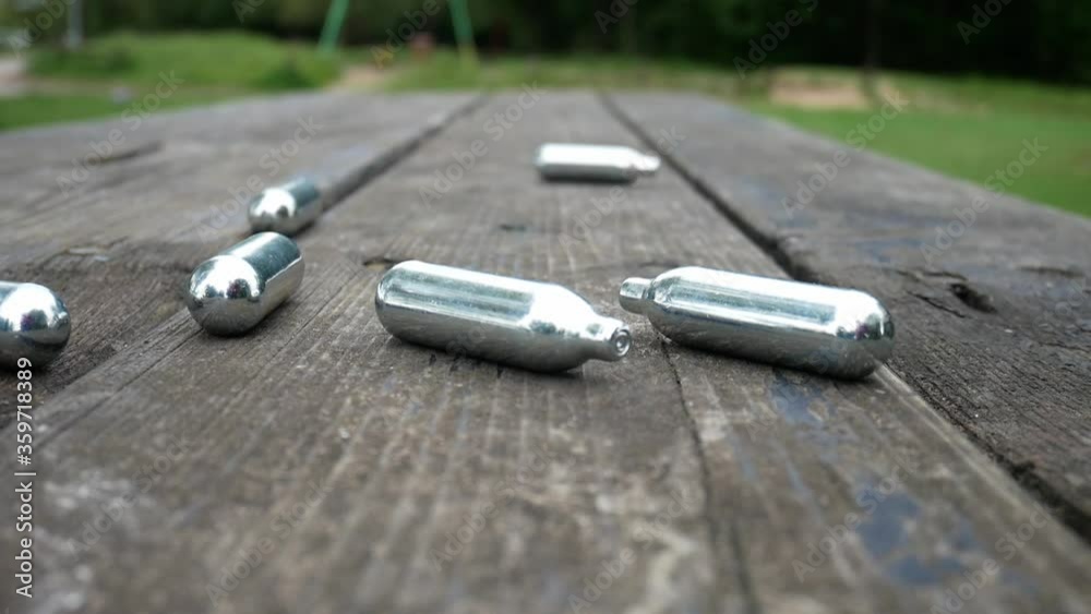 Multiple chrome drug nitrous oxide laughing gas drug cylinders pan left ...