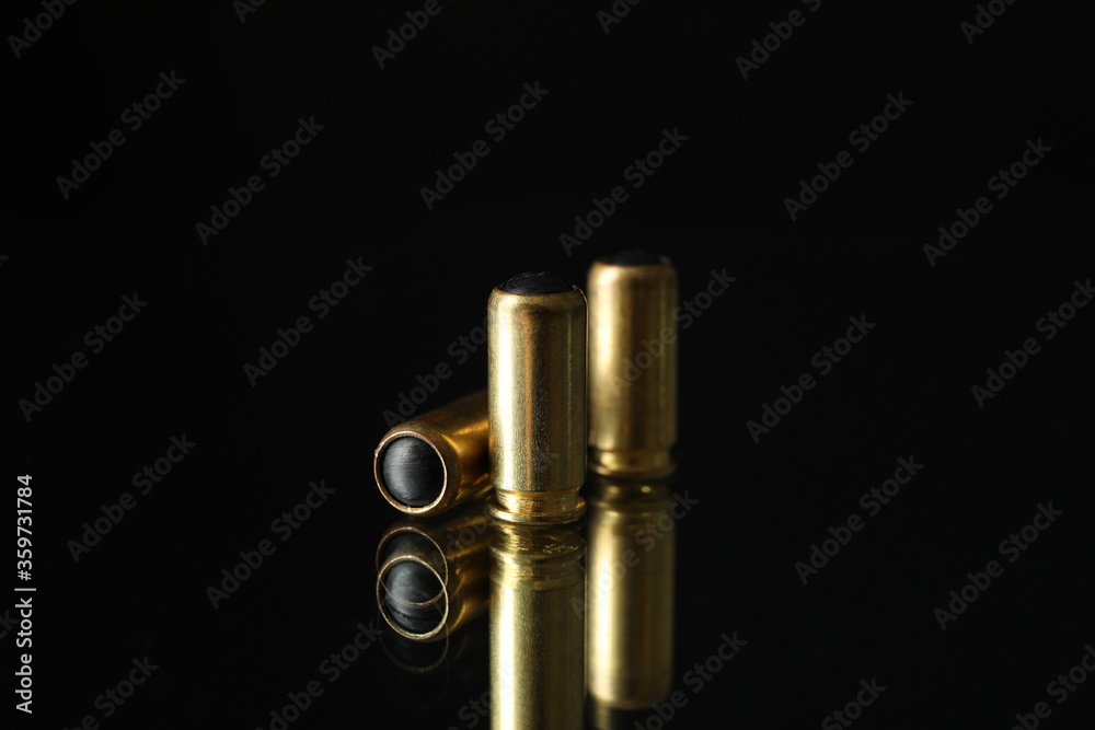 Rubber bullets on mirror background. Self defense weapon Stock Photo ...