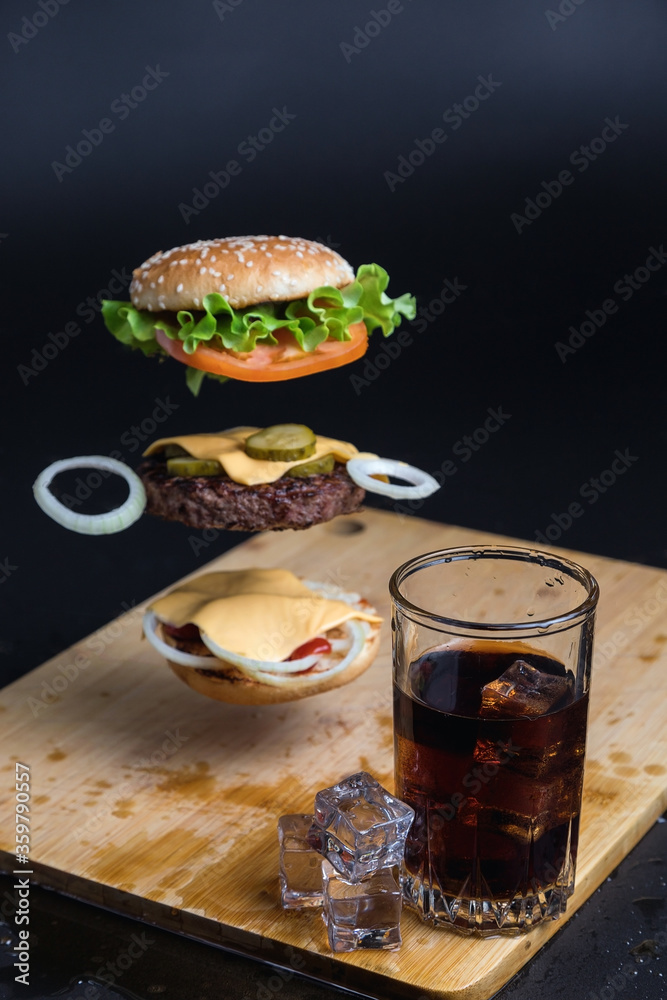 Classic Burger. Still life of a Burger and coke. Drink in a tall glass ...