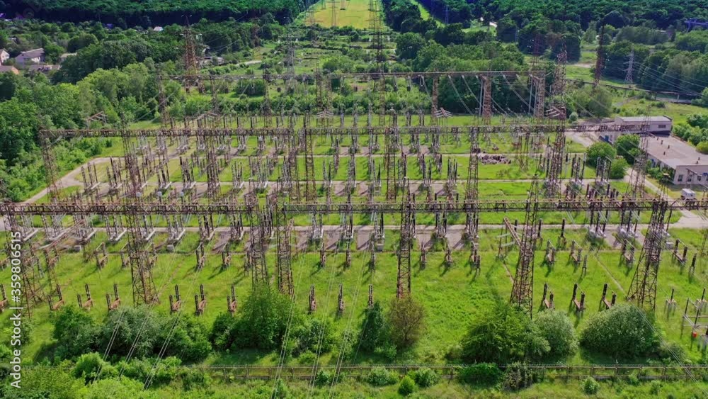 High voltage steel pylons in green field. View from above the power ...