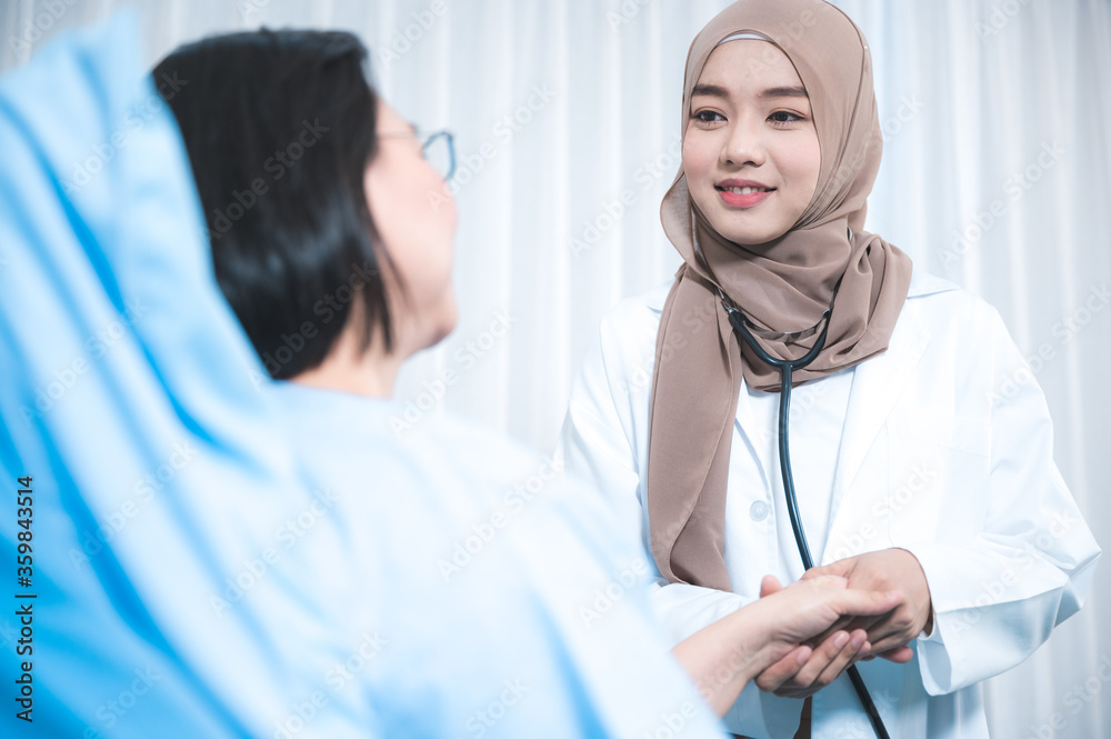 The beautiful Muslim doctor wear hijab works at the hospital to take ...