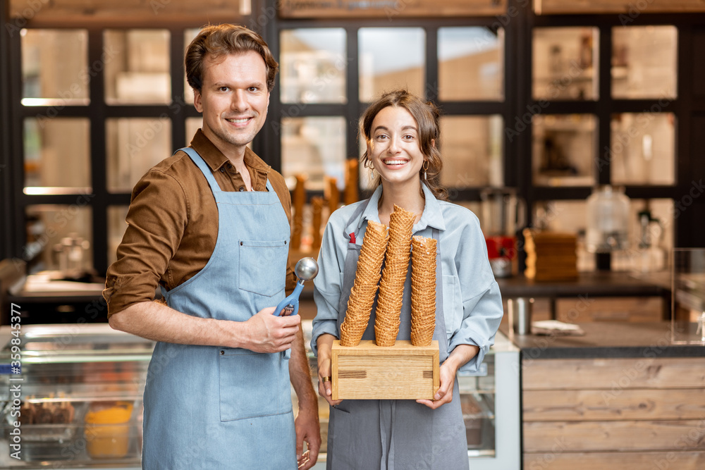 Portrait of a two cheerful employees of a cafe or small pastry shop ...