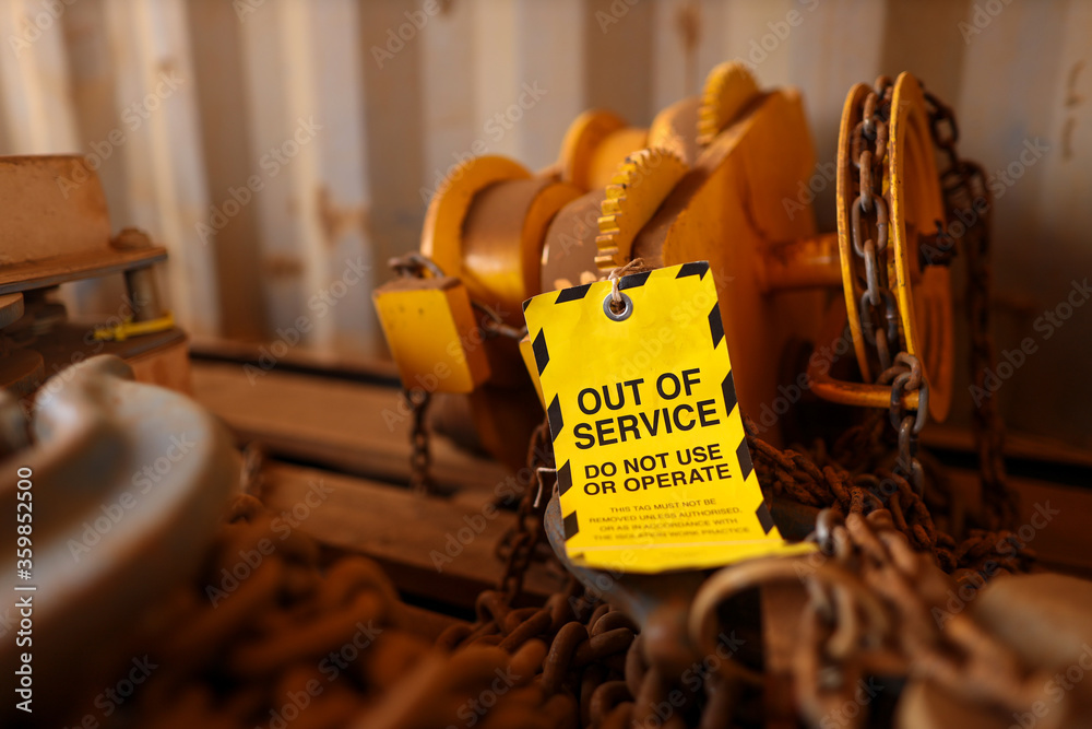Safety workplaces yellow out of service tag attached on faulty damage ...