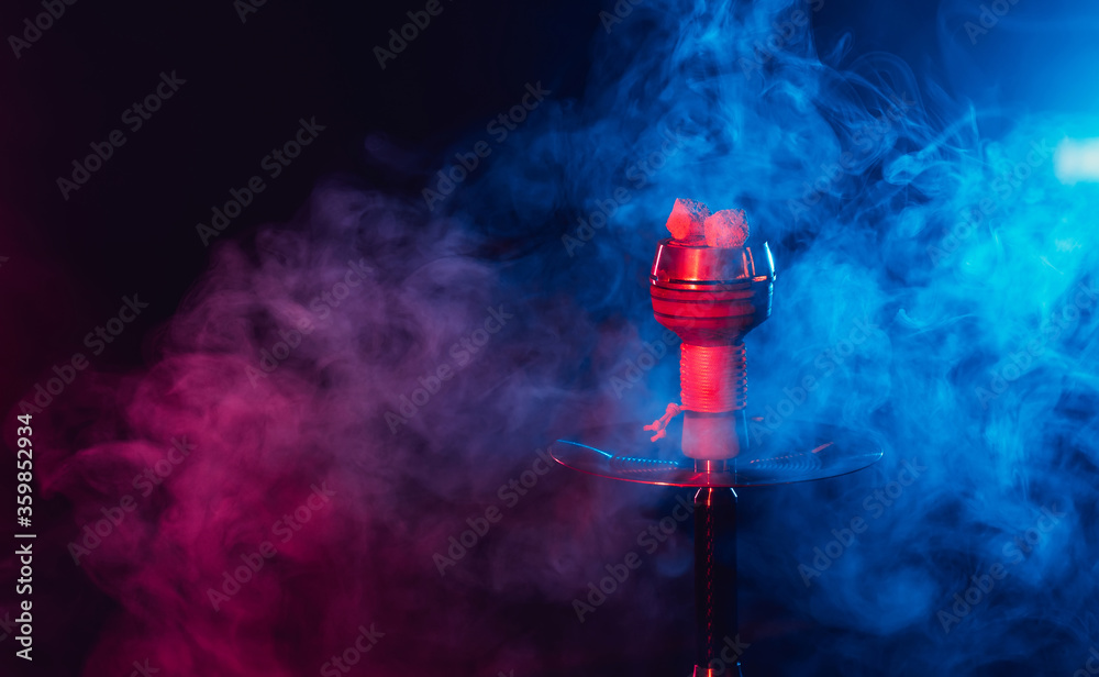 shisha red hot coals for hookah in a metal bowl against a background of ...