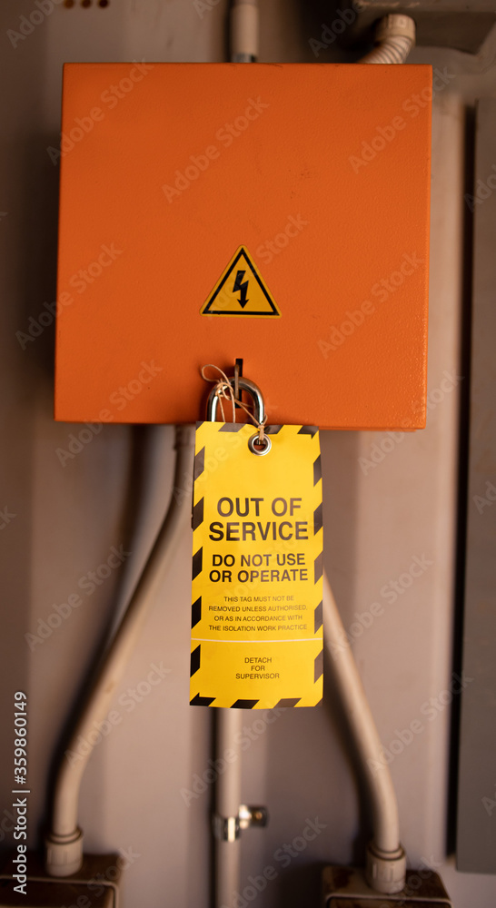 Safety workplaces yellow out of service tag attached on faulty damage ...