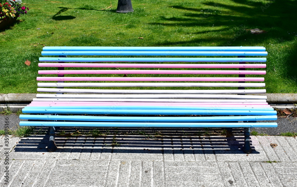 Gay pride bench at public park. Colours of transgender pride flag. A ...