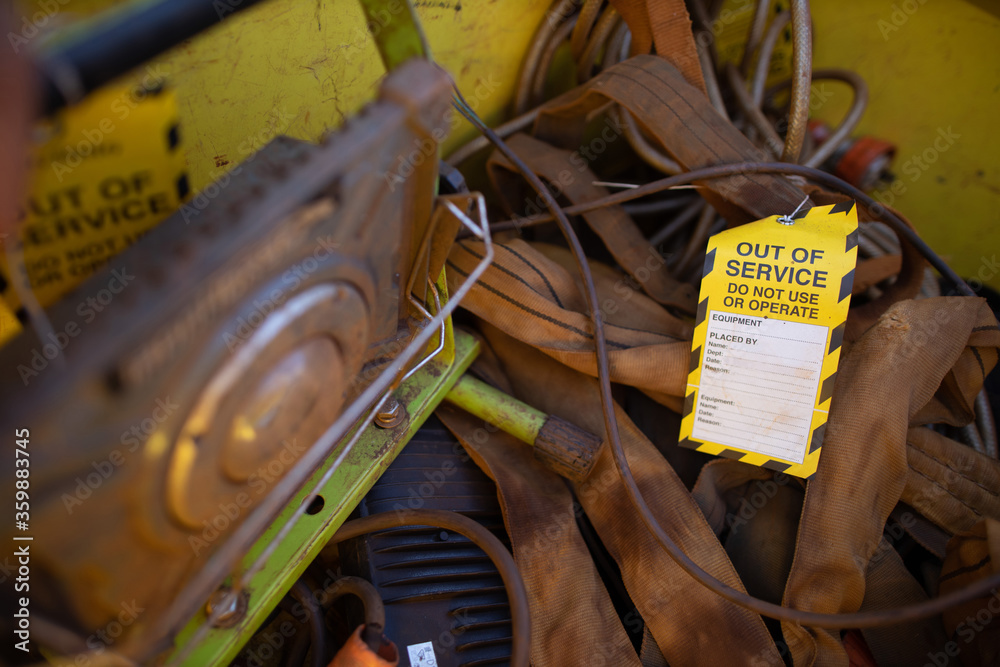 Safety workplaces yellow out of service tag on faulty damage defect on ...