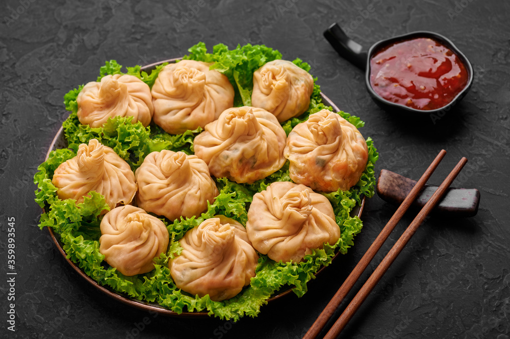 Veg Momos on black slate table top. Momos is the popular dish of indian ...