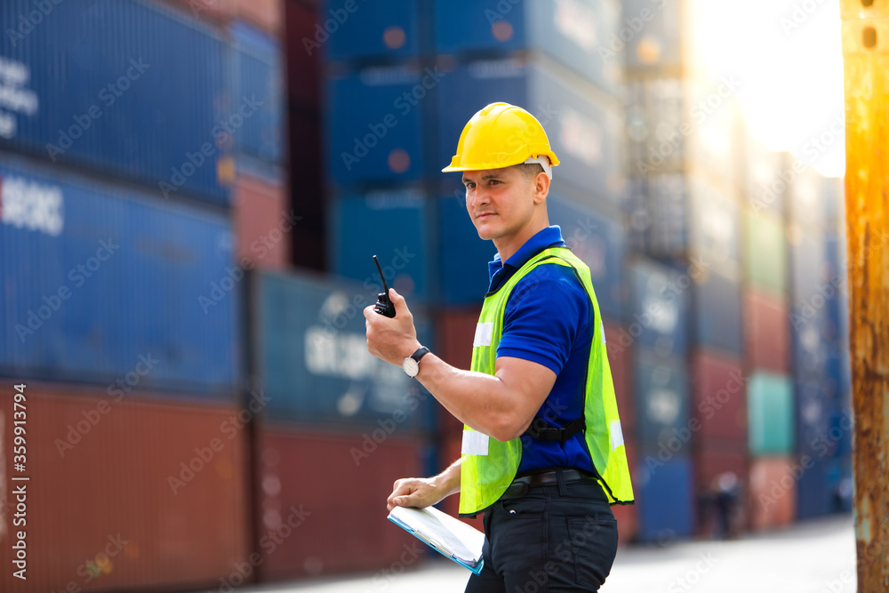 foreman maneger working through a radio communication with the workers ...