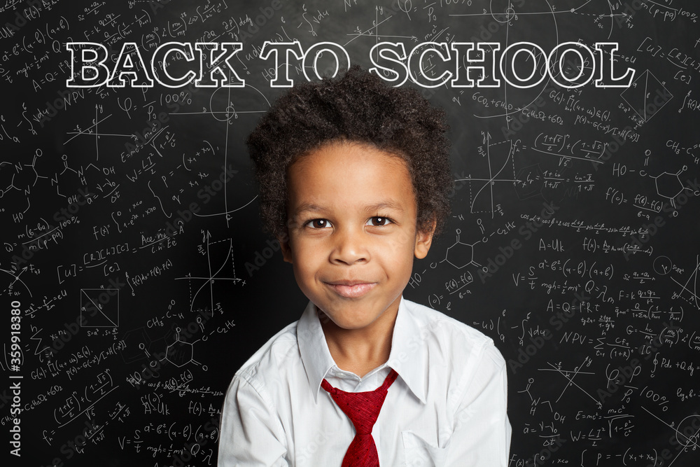 Black kid on chalkboard background. Back to school concept Stock Photo ...