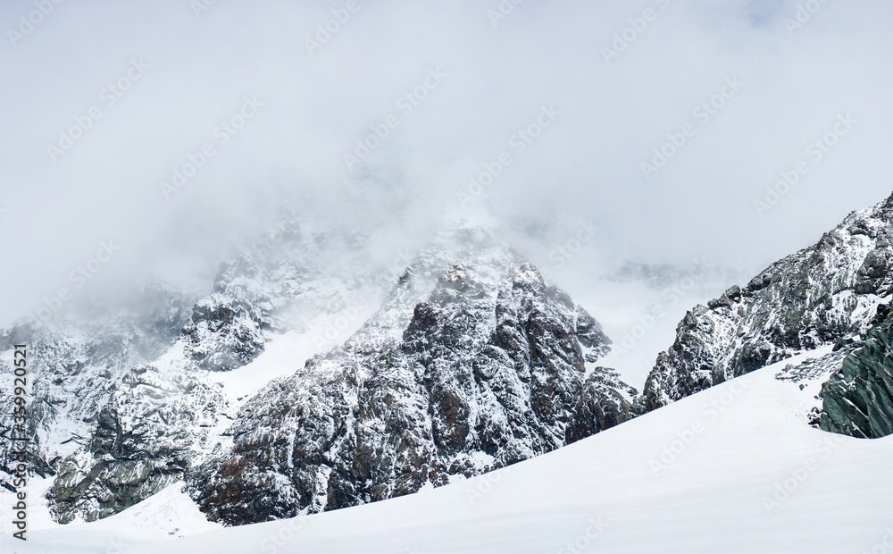Fantastic scenery of rocky mountains covered with snow. Panoramic view ...