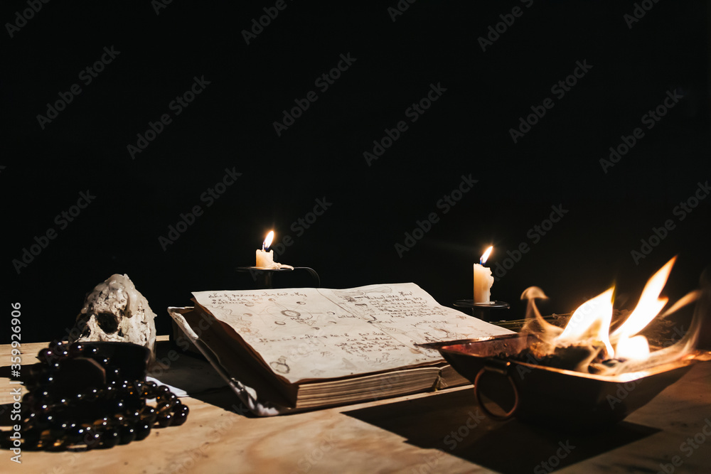 Occult white magic ritual of fire using grimoire, old book, candles ...