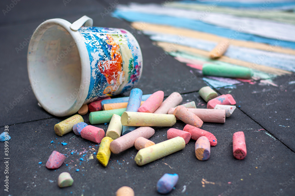 Large colored street chalk. Plastic bucket with sidewalk chalk with ...