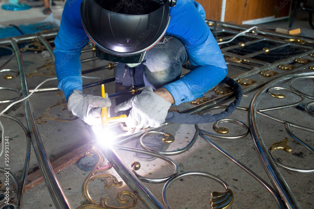 Welders are welding the various parts of building a stainless steel ...