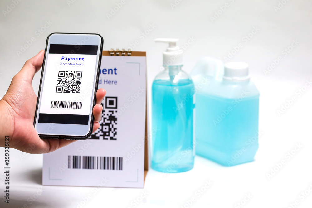 Hand holding smart phone to scan QR code payment with blurry alcohol ...