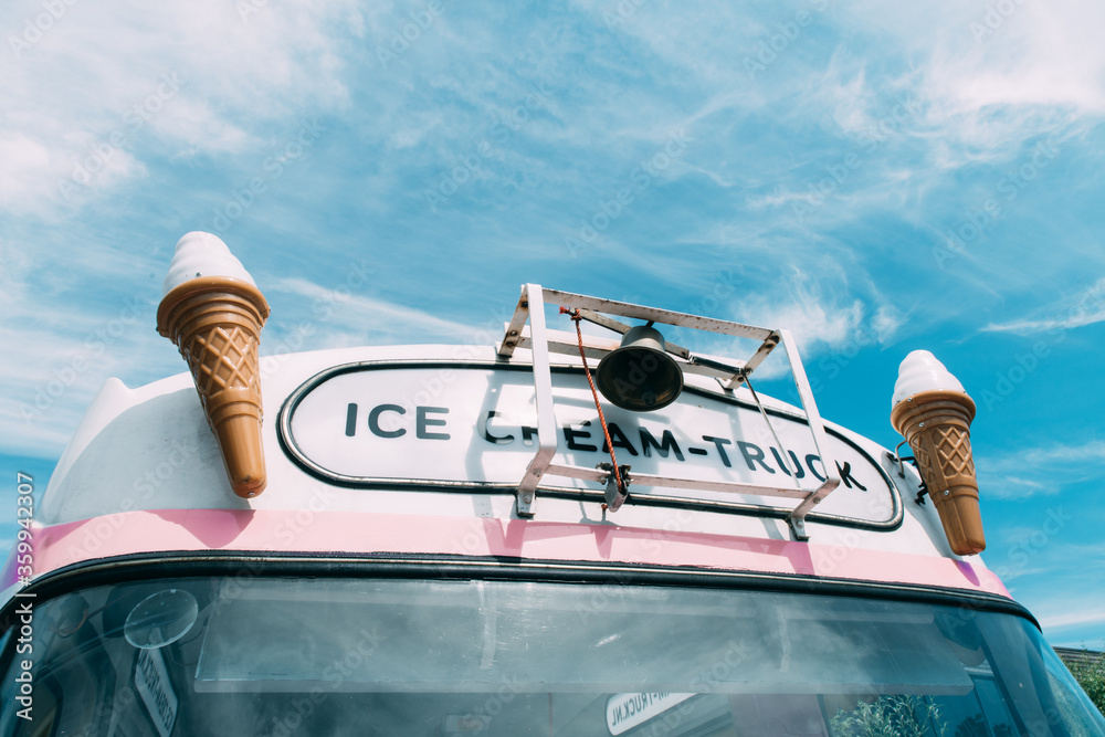 Ice cream cone with a pink retro ice cream truck or van in the ...