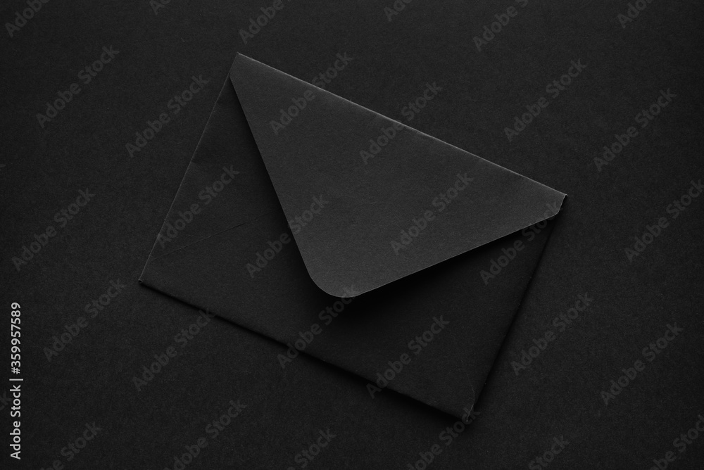 Black envelope on a black background. Stock Photo | Adobe Stock