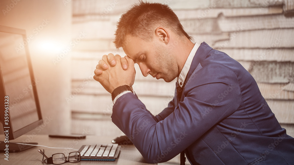 Foto de Tired business man at workplace in office holding his head on ...