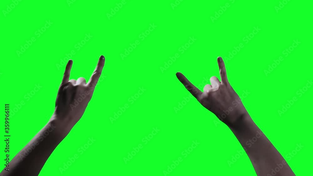 Stockvideon Woman Hand showing Devil Horns against Green Background ...