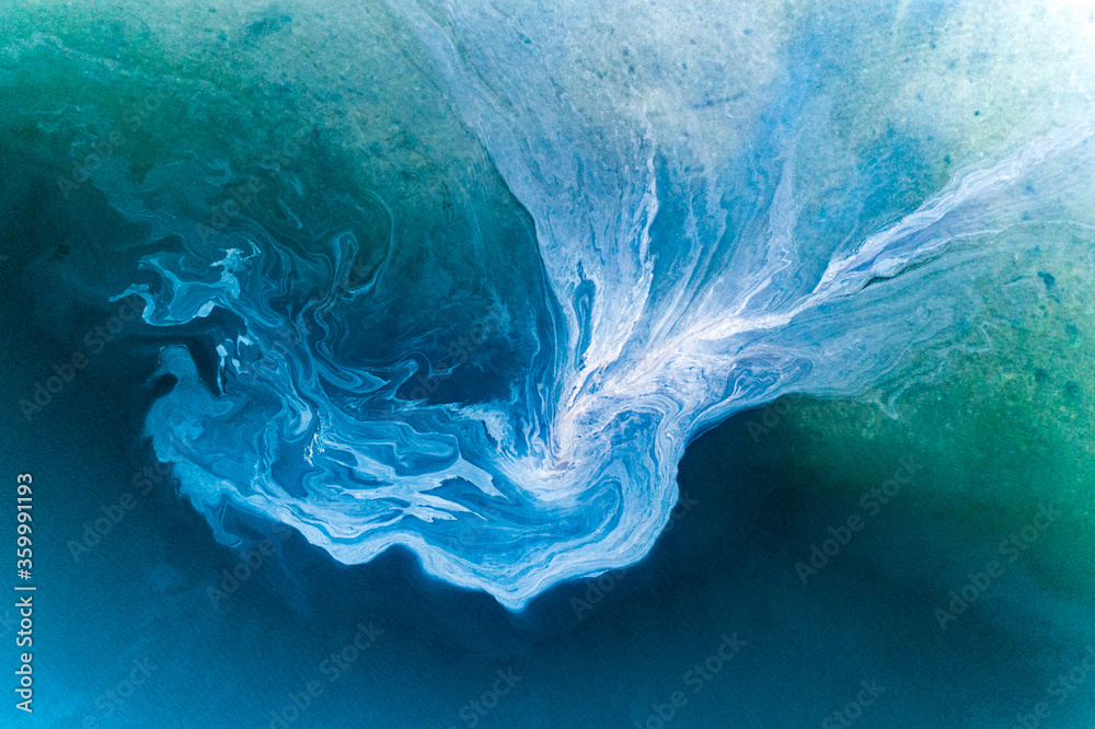 Leachate flowing off tidal mud flats near an anchored yacht. Stock ...