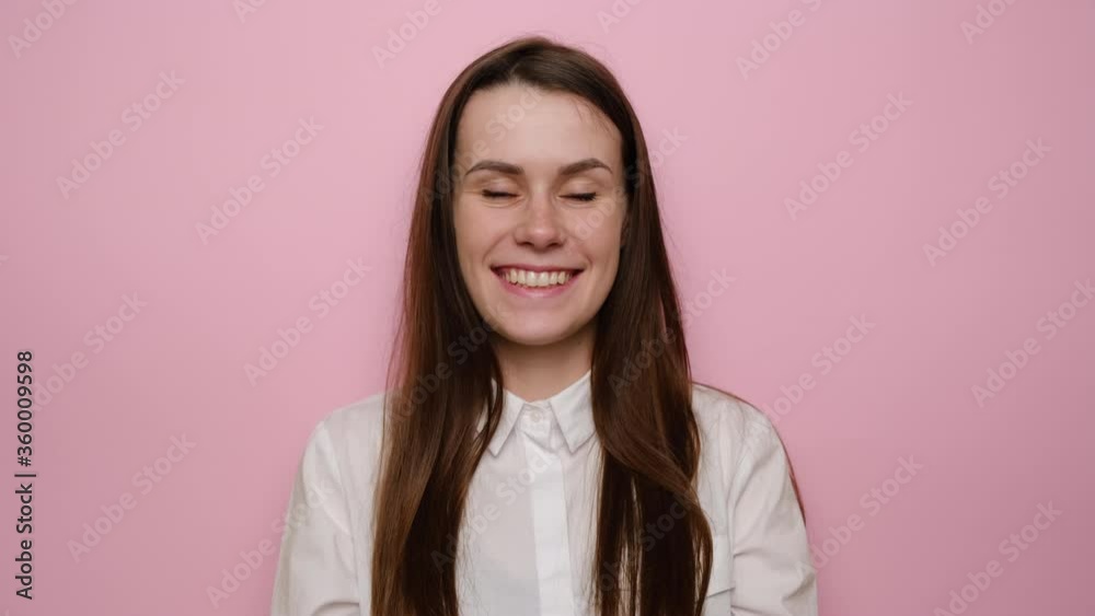 Impressed beautiful young woman spreads palms with excitement, smiles ...