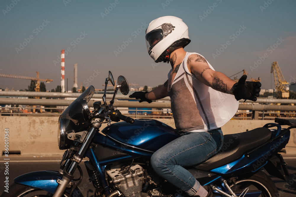 Man Spreading His Arms While Riding Motorcycle Stock Photo | Adobe Stock