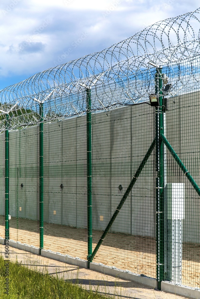 Barbed wire and concrete wall. Military base. State border. Prison wall ...