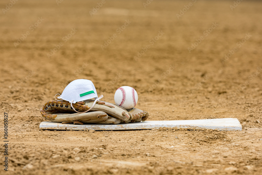Baseball glove, ball and N95 respirator face mask at baseball field ...